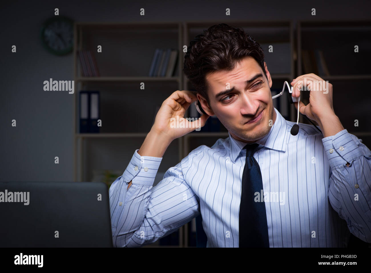 Tired and exhausted helpdesk operator during night shift Stock Photo ...