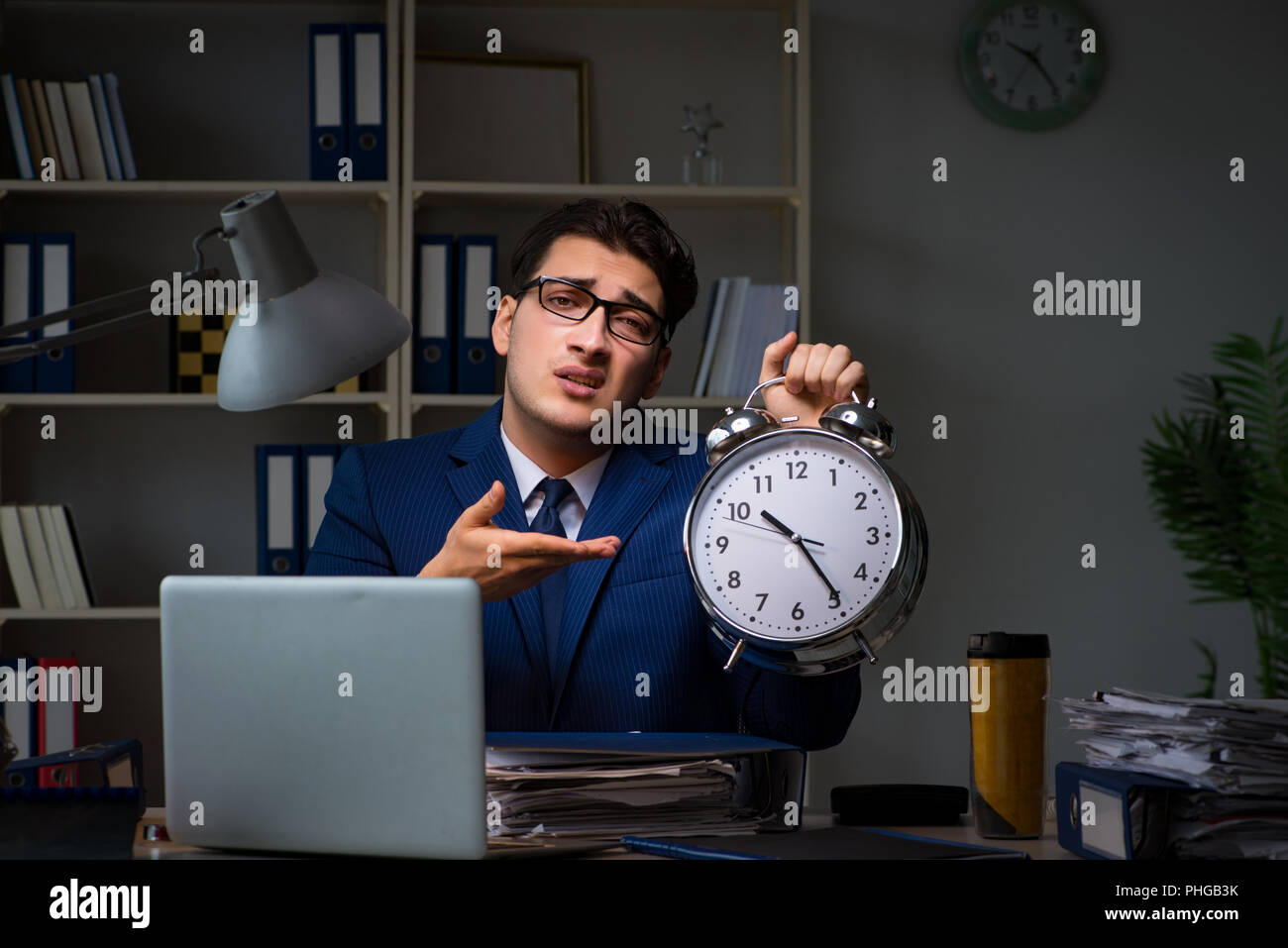 Employee staying late to finish work on auditing Stock Photo - Alamy