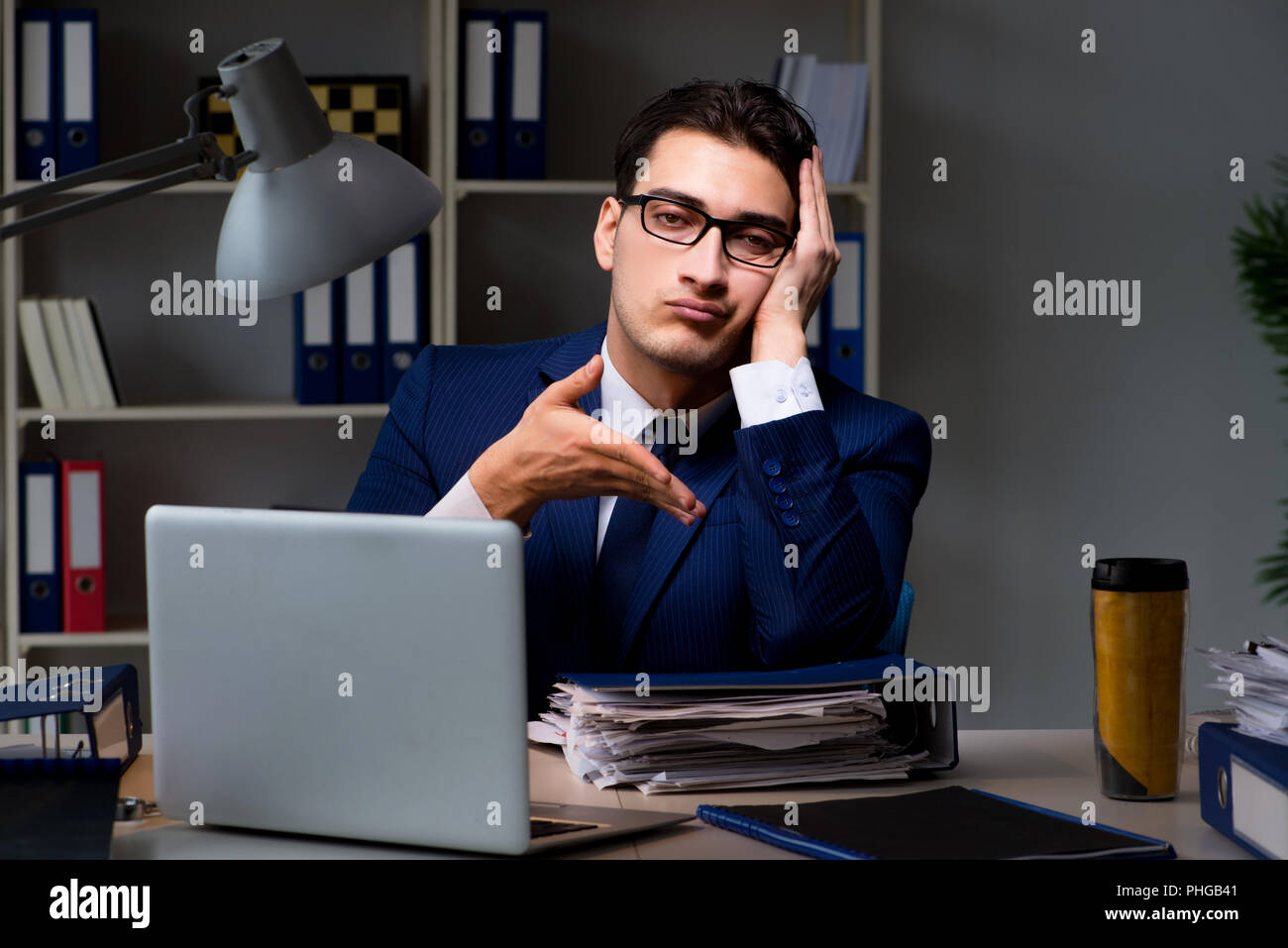 Employee working late to finish important deliverable task Stock Photo ...