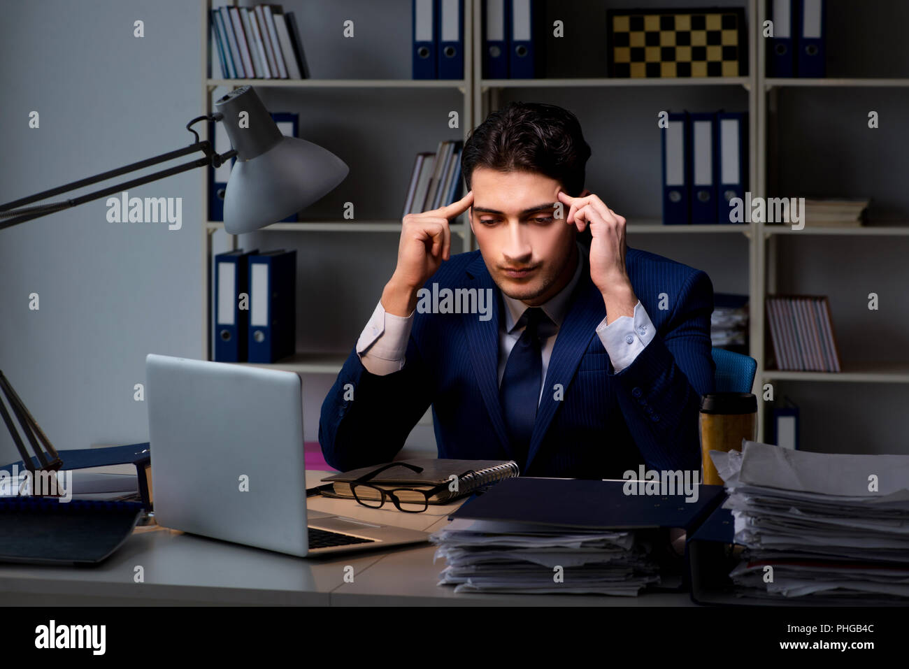 Employee working late to finish important deliverable task Stock Photo ...