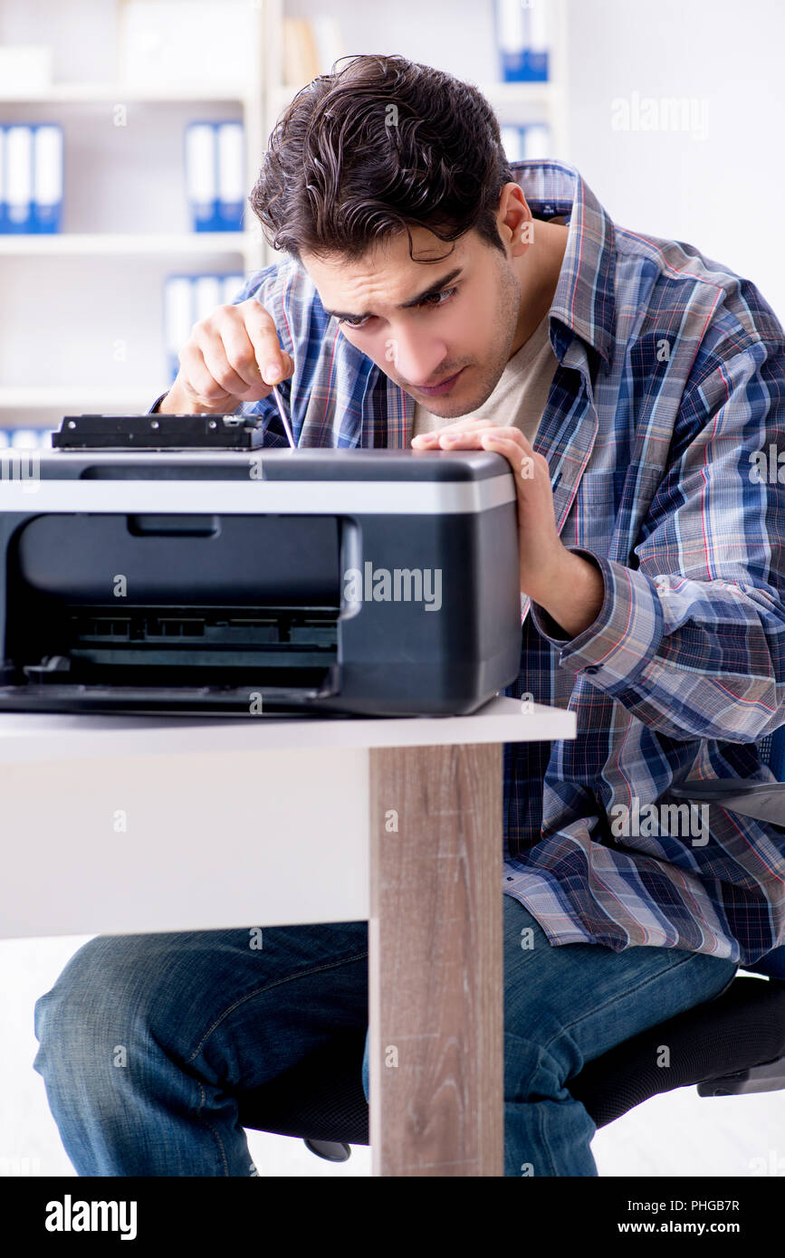 Hardware repairman repairing broken printer fax machine Stock Photo - Alamy