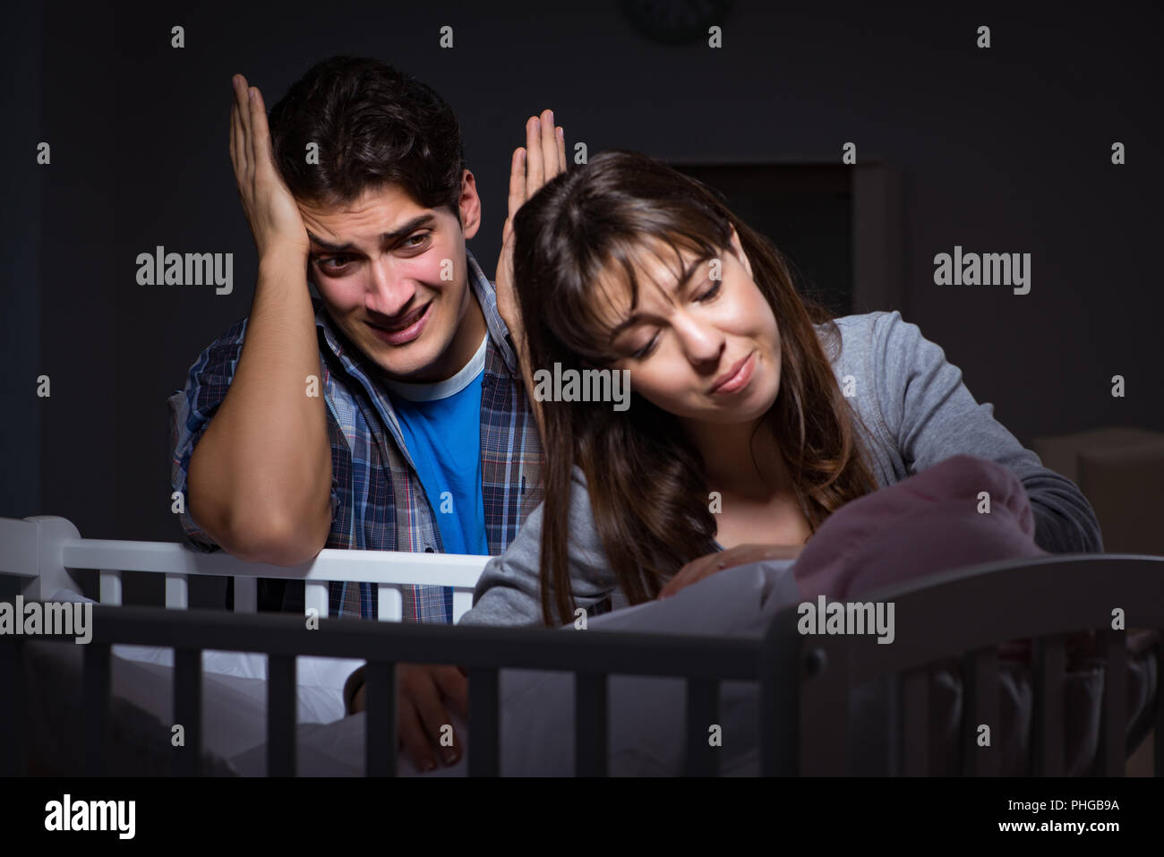 Young parents sleepless with newborn baby at night Stock Photo - Alamy
