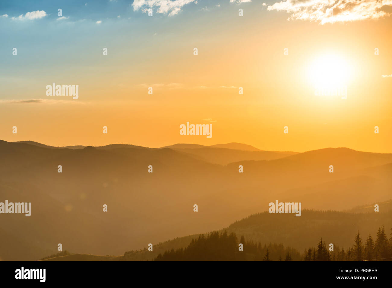 Sunset in the mountains Stock Photo - Alamy