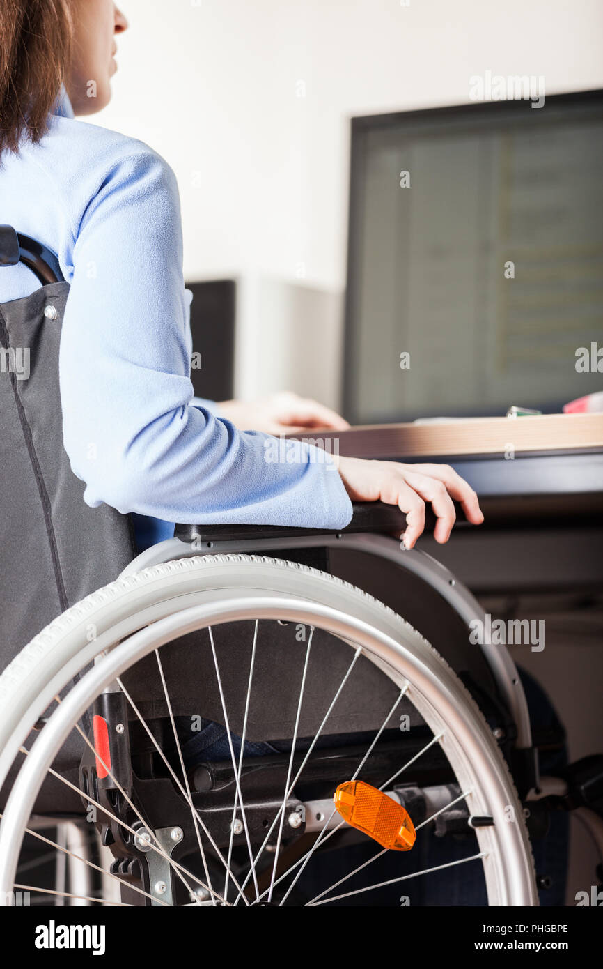 Invalid or disabled woman sitting wheelchair working office desk ...