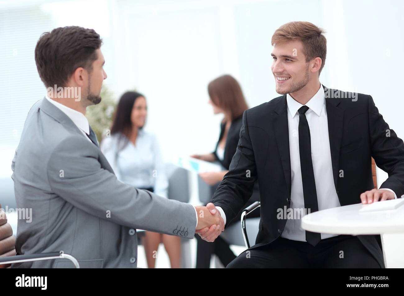 handshake Manager and the client in the office Stock Photo - Alamy