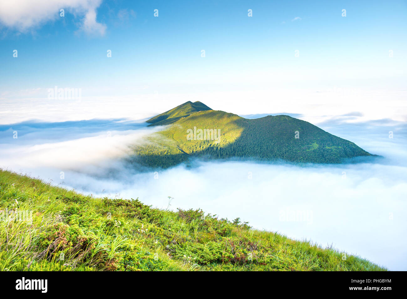 Green mountain in the clouds Stock Photo - Alamy