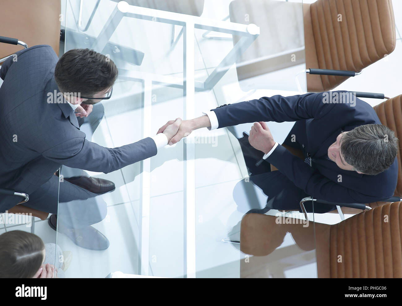 Handshake across the table. Meeting around a boardroom table Stock ...