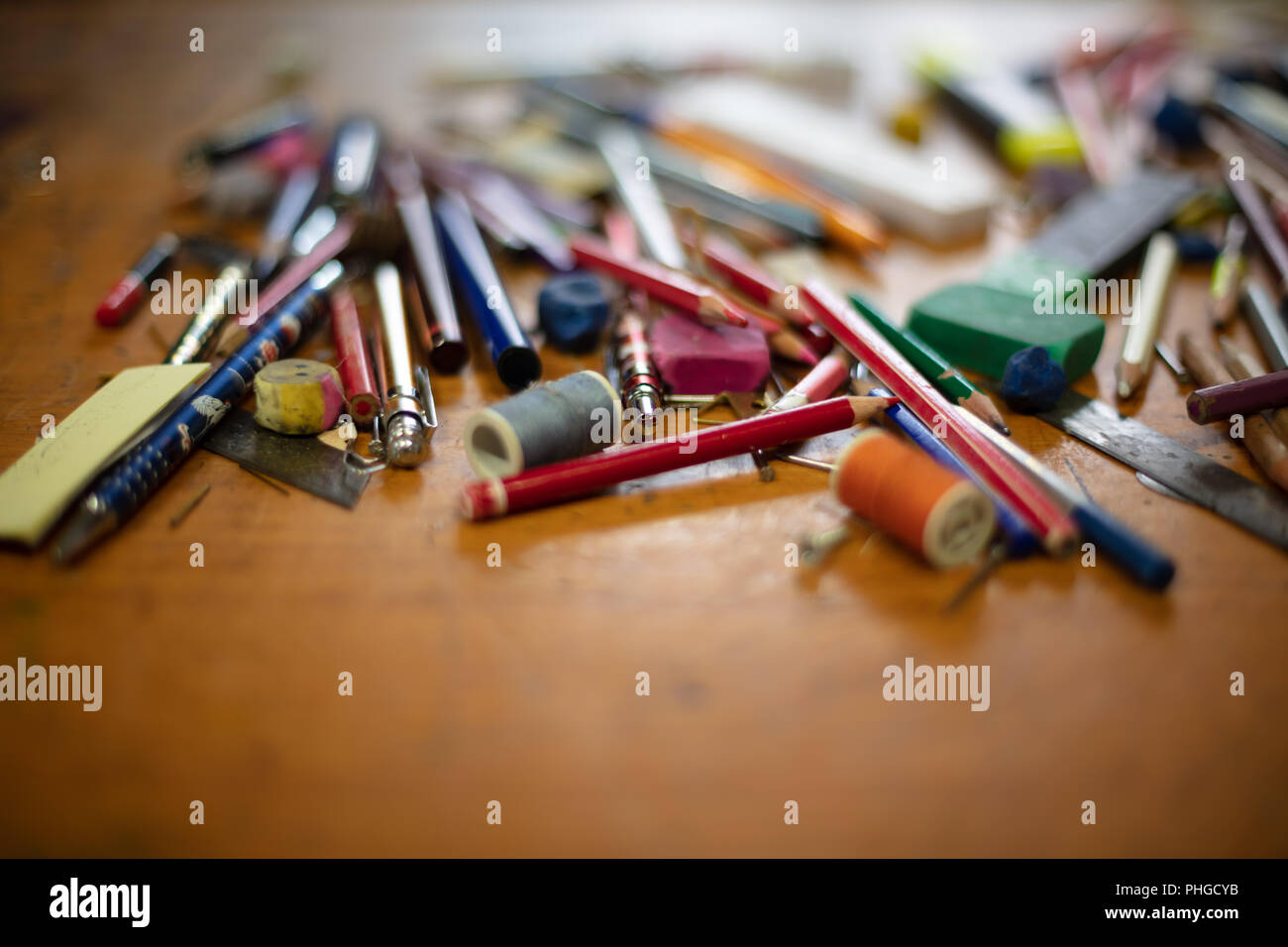 Assorted objects ; colored pencils, pens, crayons, erasers, binder ...