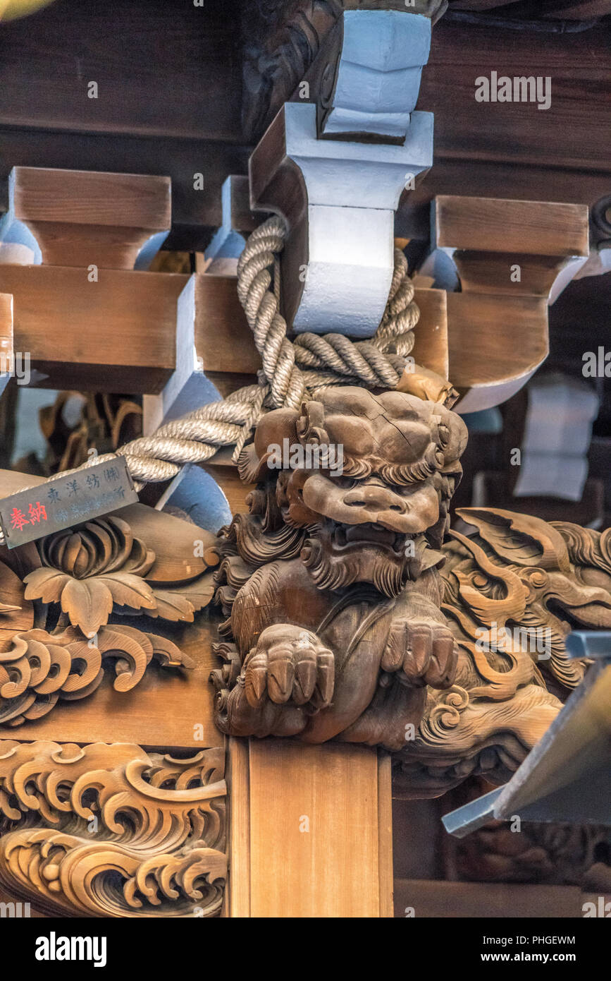 Shishi carved guardian Lion nosing at Koami Shrine or Koami Inari ...
