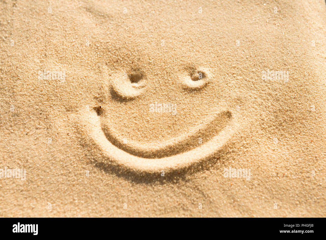 Smile on the sand Stock Photo - Alamy