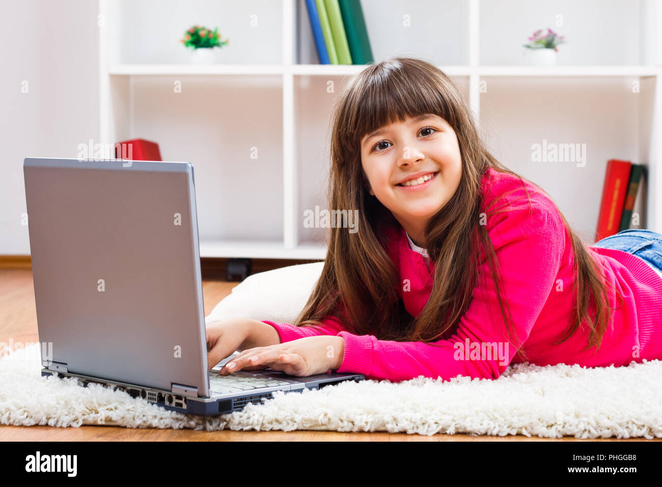 Little girl using laptop Stock Photo - Alamy