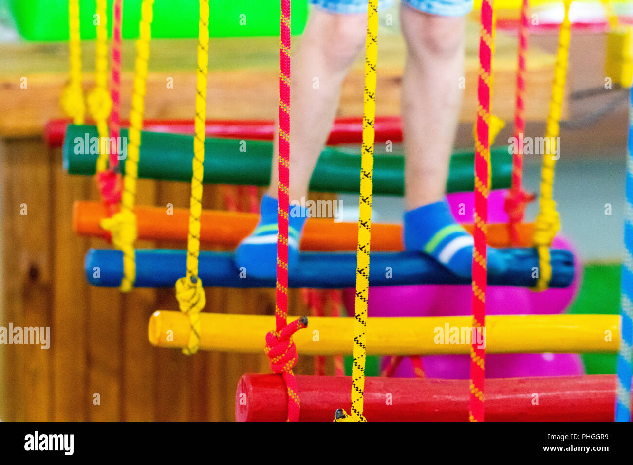 Children's feet at the playground with swinging bridge Stock Photo - Alamy