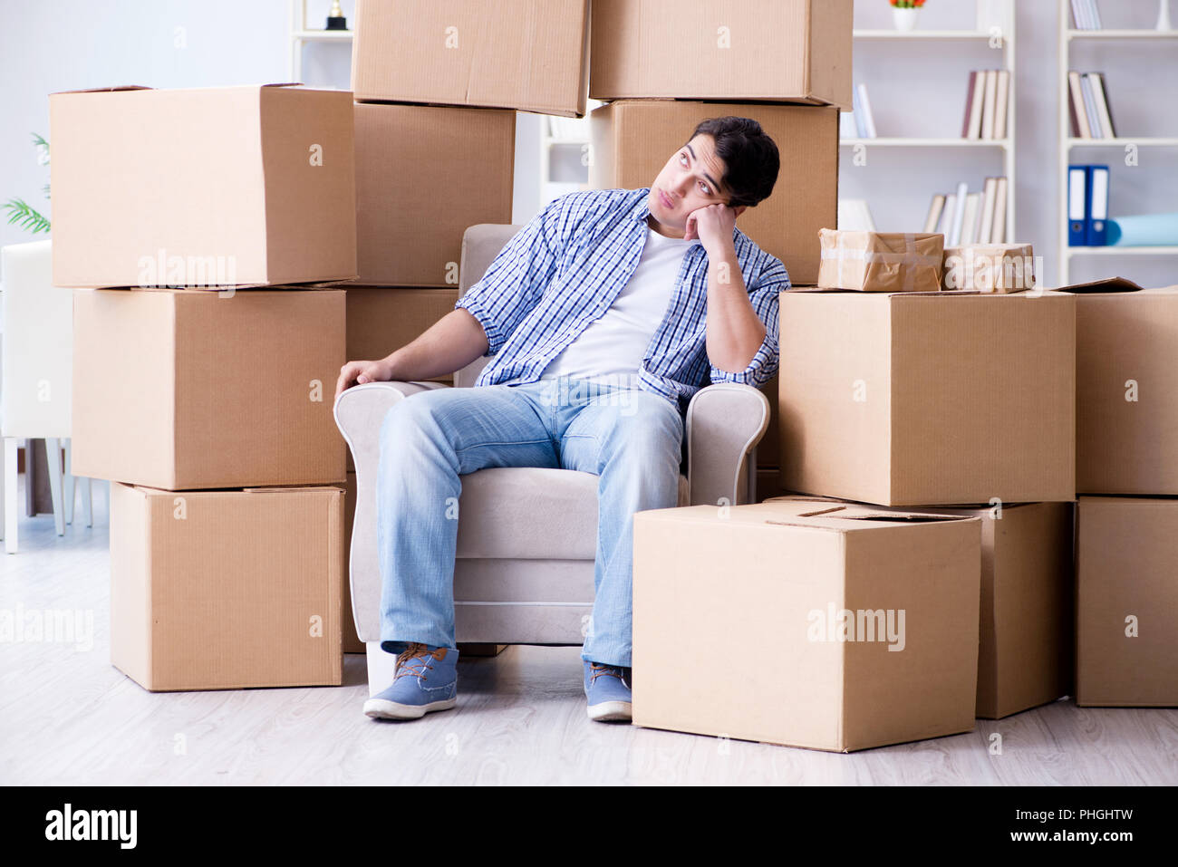 Young man moving in to new house with boxes Stock Photo - Alamy