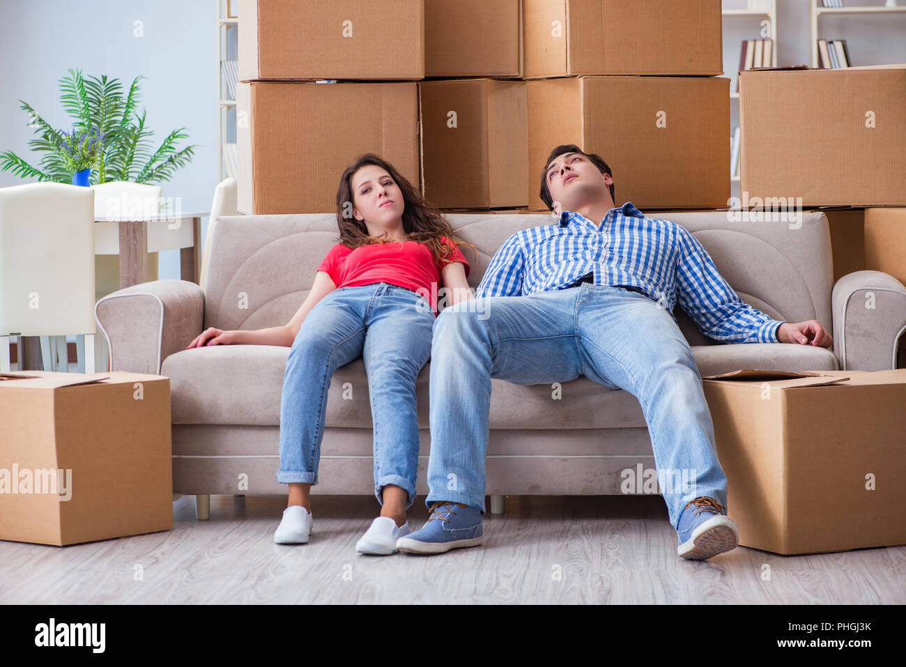 Young pair moving in to new house with boxes Stock Photo - Alamy