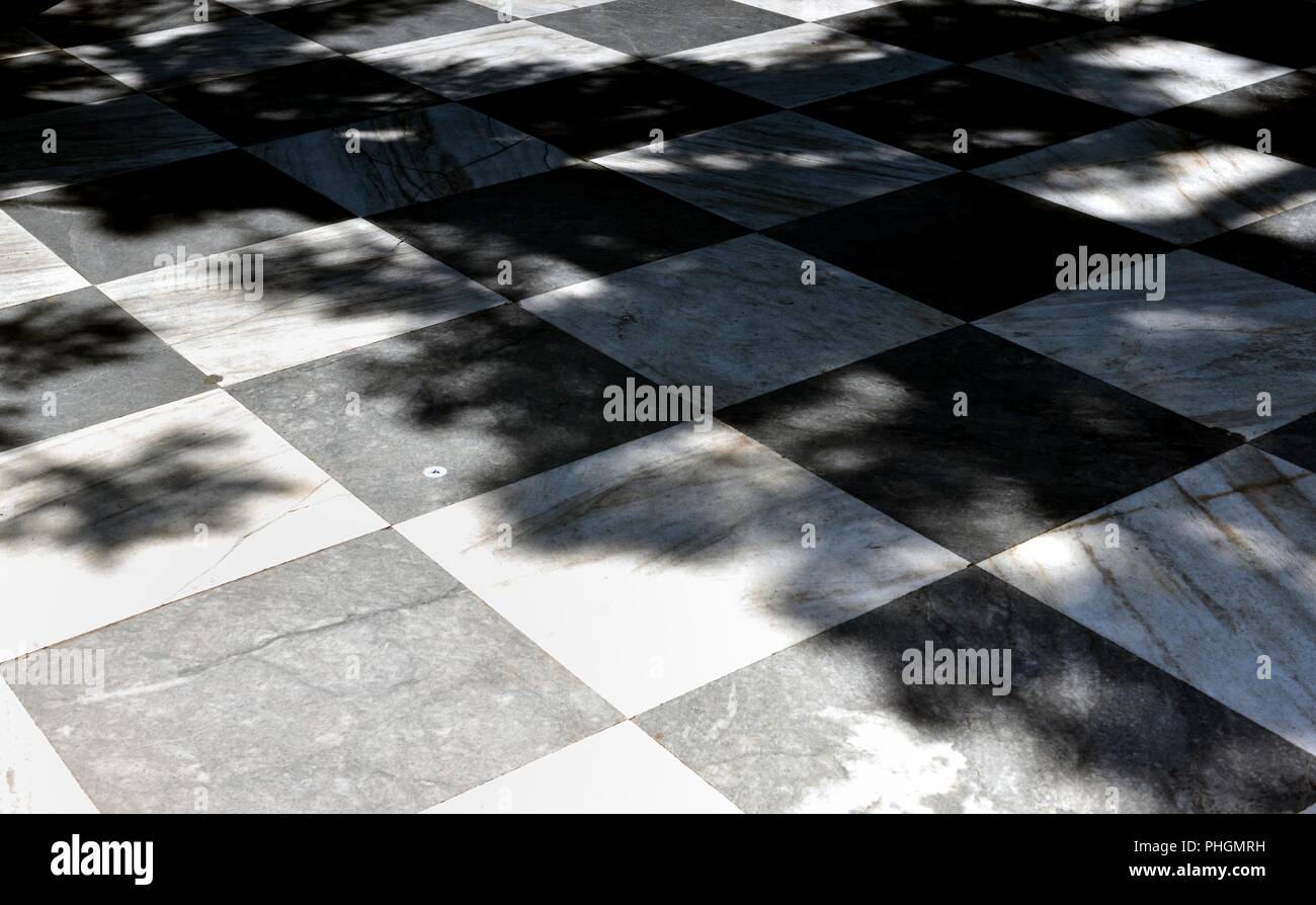 Checkerboard of black and white floor tiles Stock Photo - Alamy