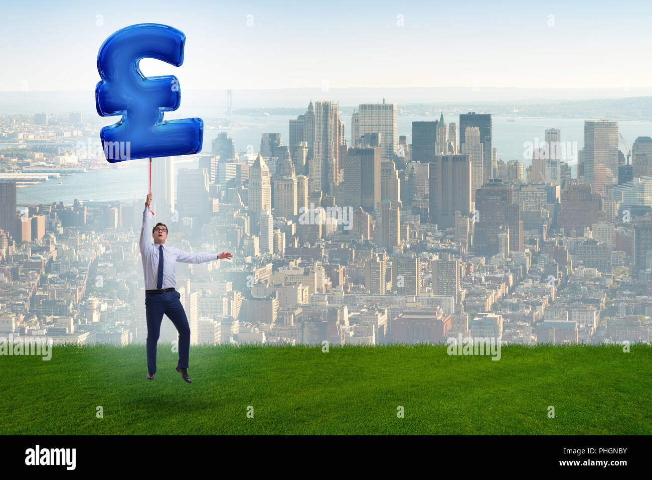 Businessman flying on british pound sign inflatable balloon Stock Photo ...