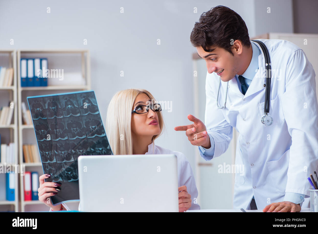 Two doctors examining x-ray images of patient for diagnosis Stock Photo ...
