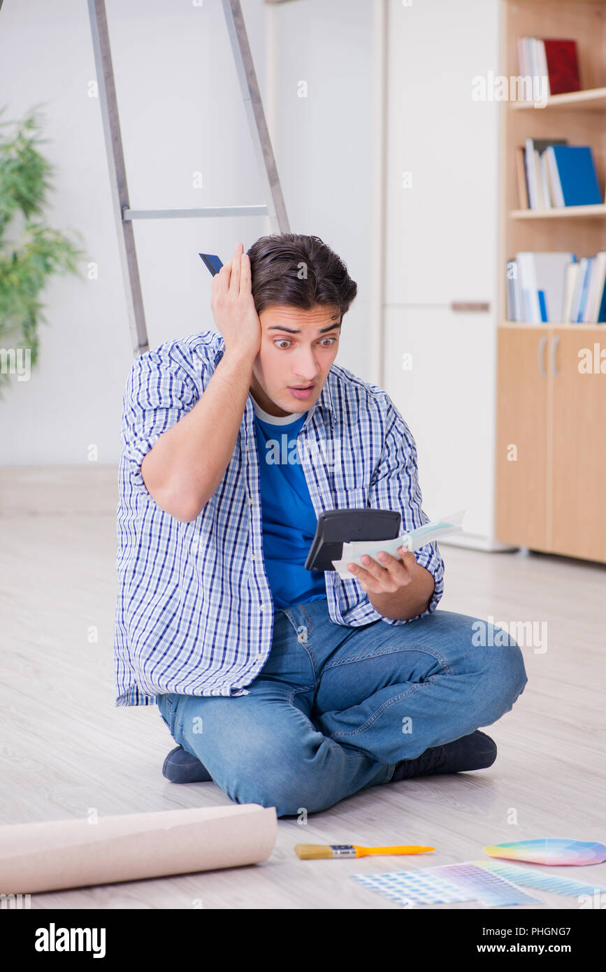 Young man overspending his budget in refurbishment project Stock Photo ...