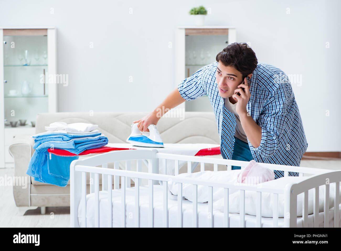 Young dad looking after newborn baby Stock Photo - Alamy
