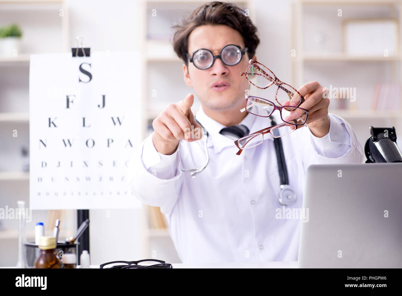 Funny eye doctor in humourous medical concept Stock Photo - Alamy