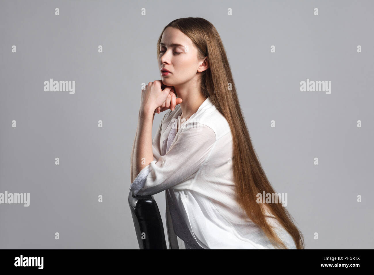 side profile view of calm beautiful young model actor with long brown ...