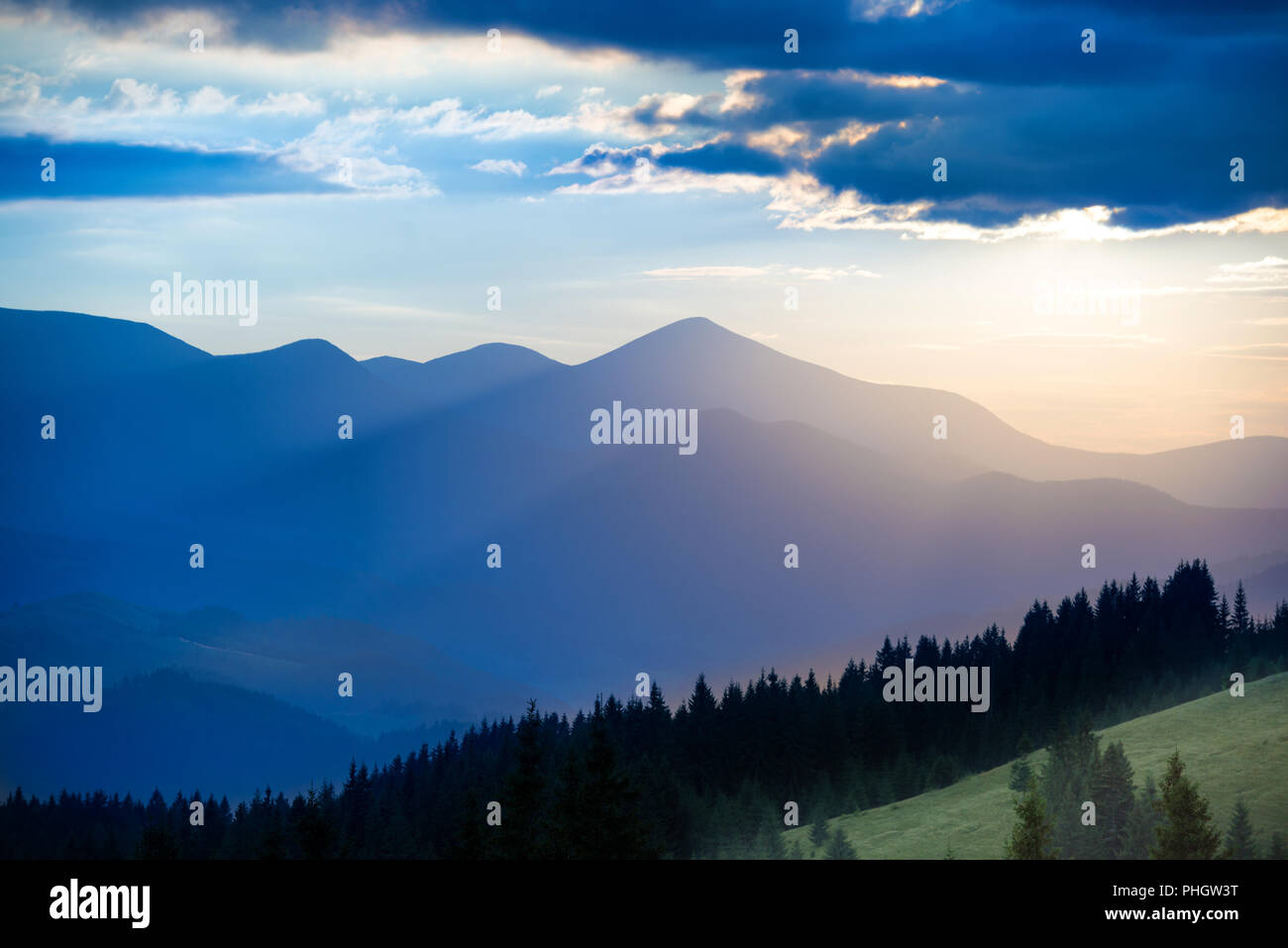 Blue mountains at sunset Stock Photo - Alamy