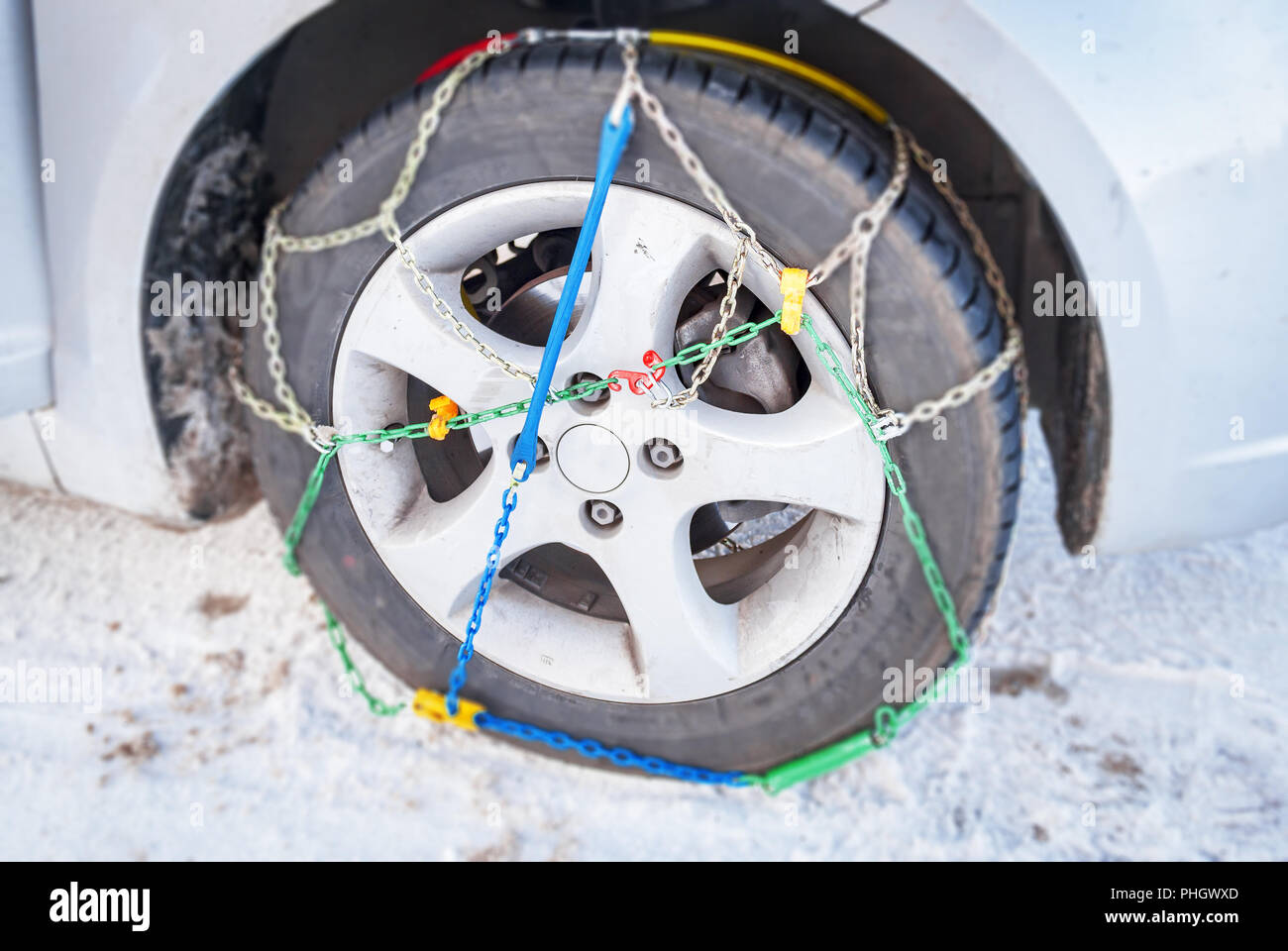 wheel of a car with mounted winter chains Stock Photo - Alamy