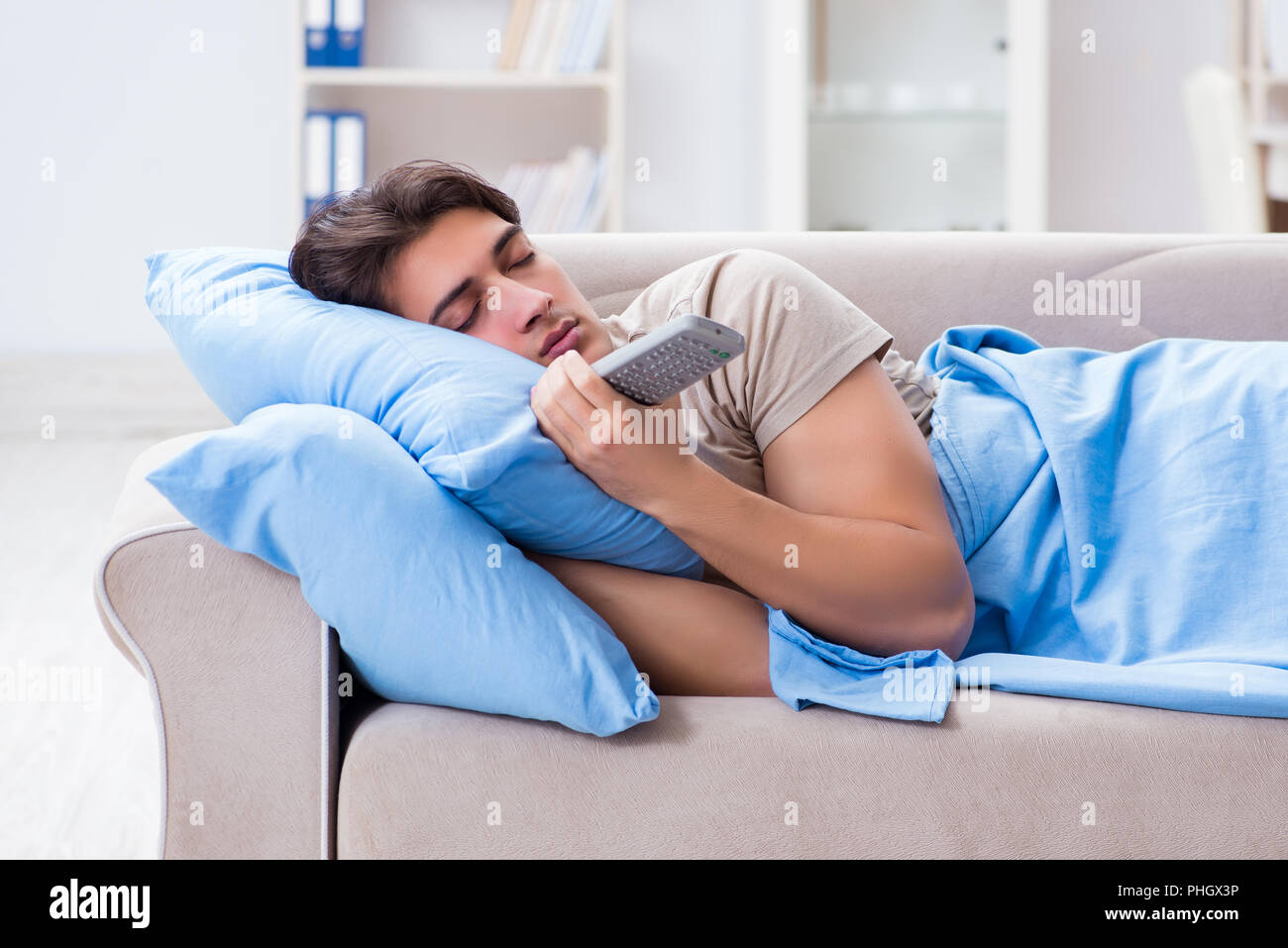 Man watching tv from bed holding remote control unit Stock Photo - Alamy