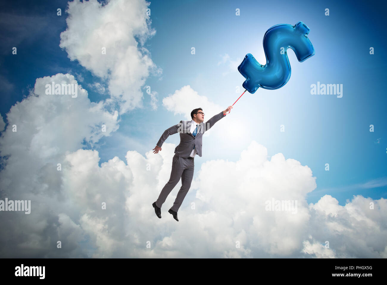 Businessman flying on dollar sign inflatable balloon Stock Photo - Alamy