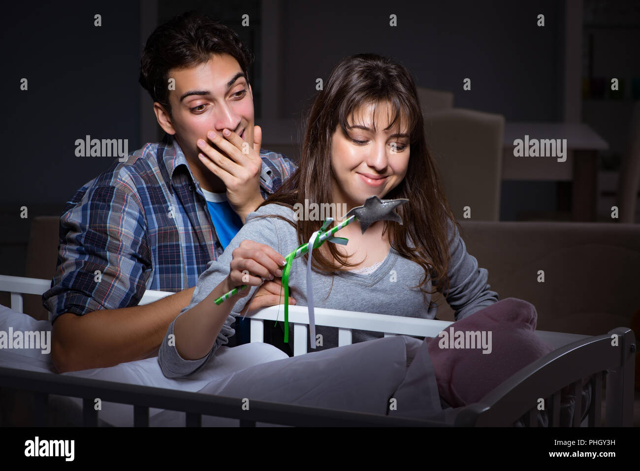 Young parents sleepless with newborn baby at night Stock Photo - Alamy