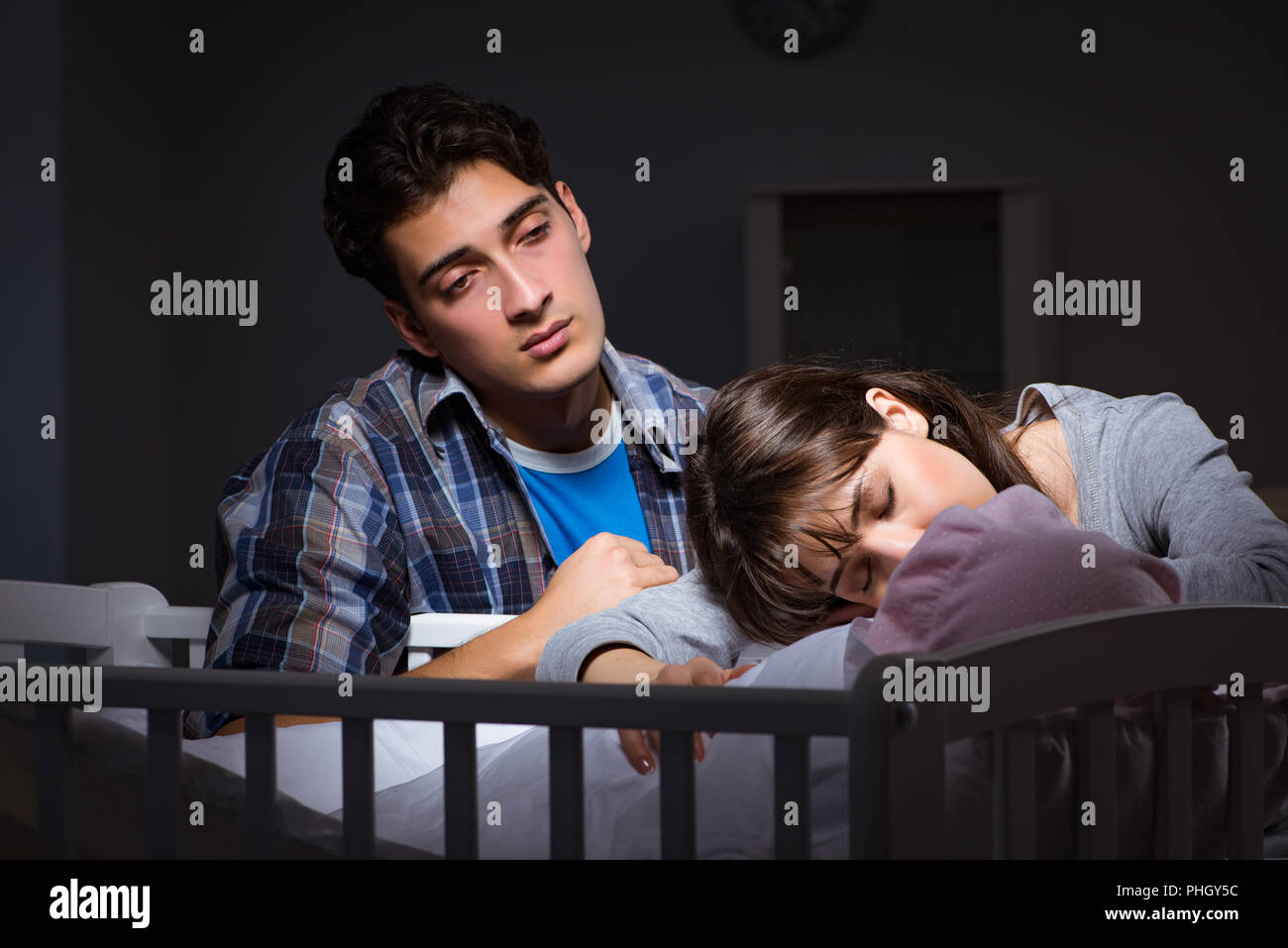 Young parents sleepless with newborn baby at night Stock Photo - Alamy