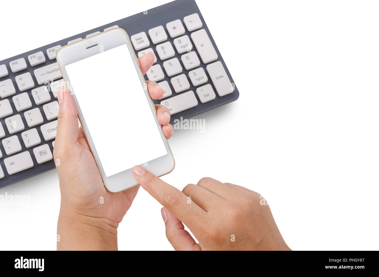 Hand holding smartphone with keyboard computer isolated on white ...