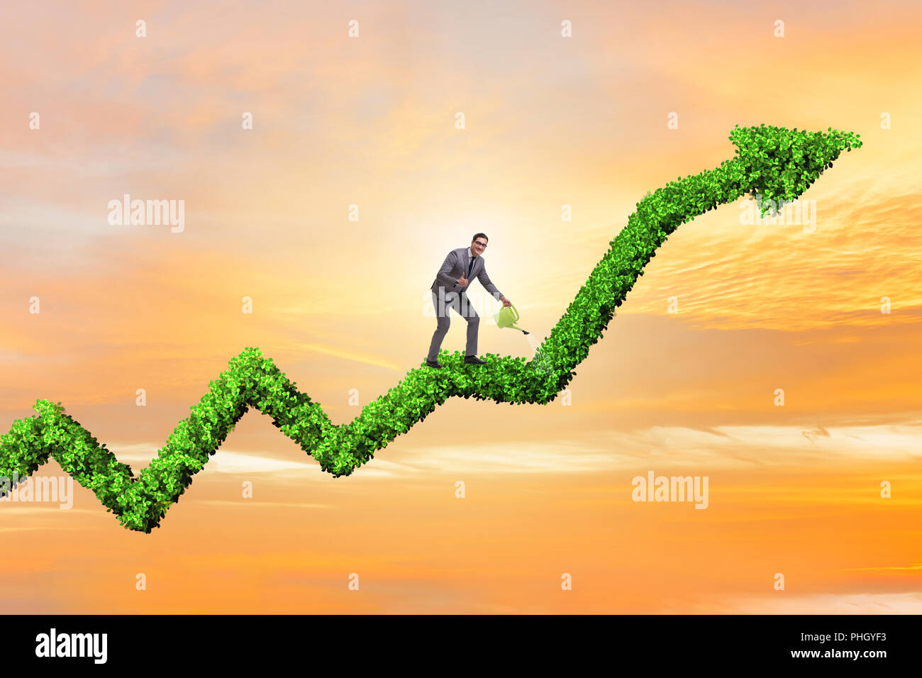 Businessman in investment concept watering financial line chart Stock ...