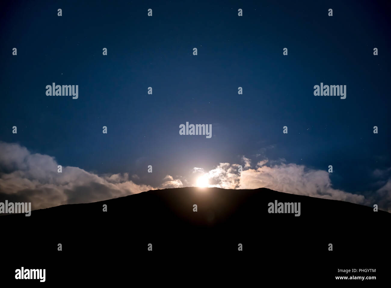Raising of full moon above mountain Stock Photo - Alamy
