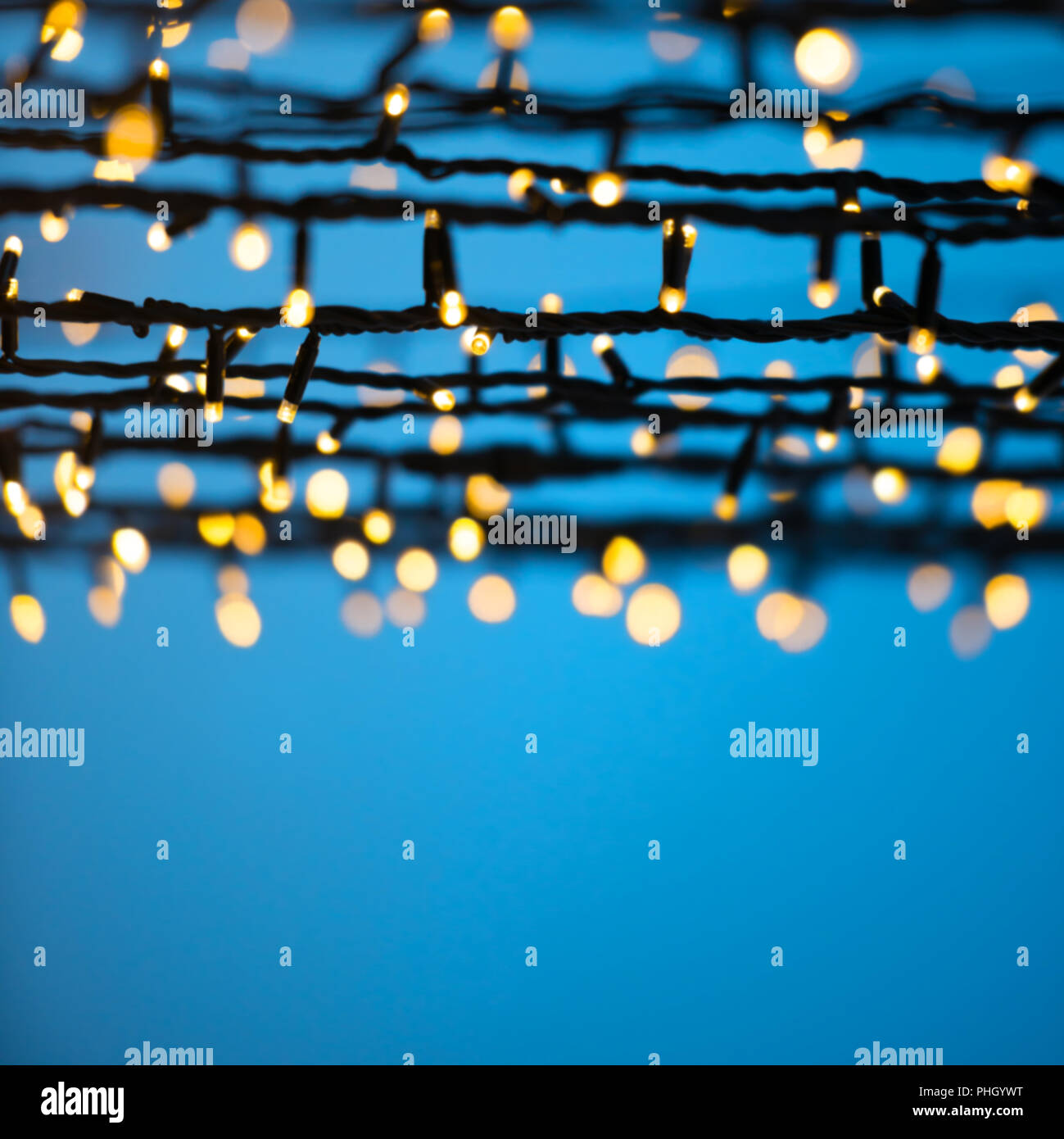 Christmas lights over blue night sky Stock Photo - Alamy