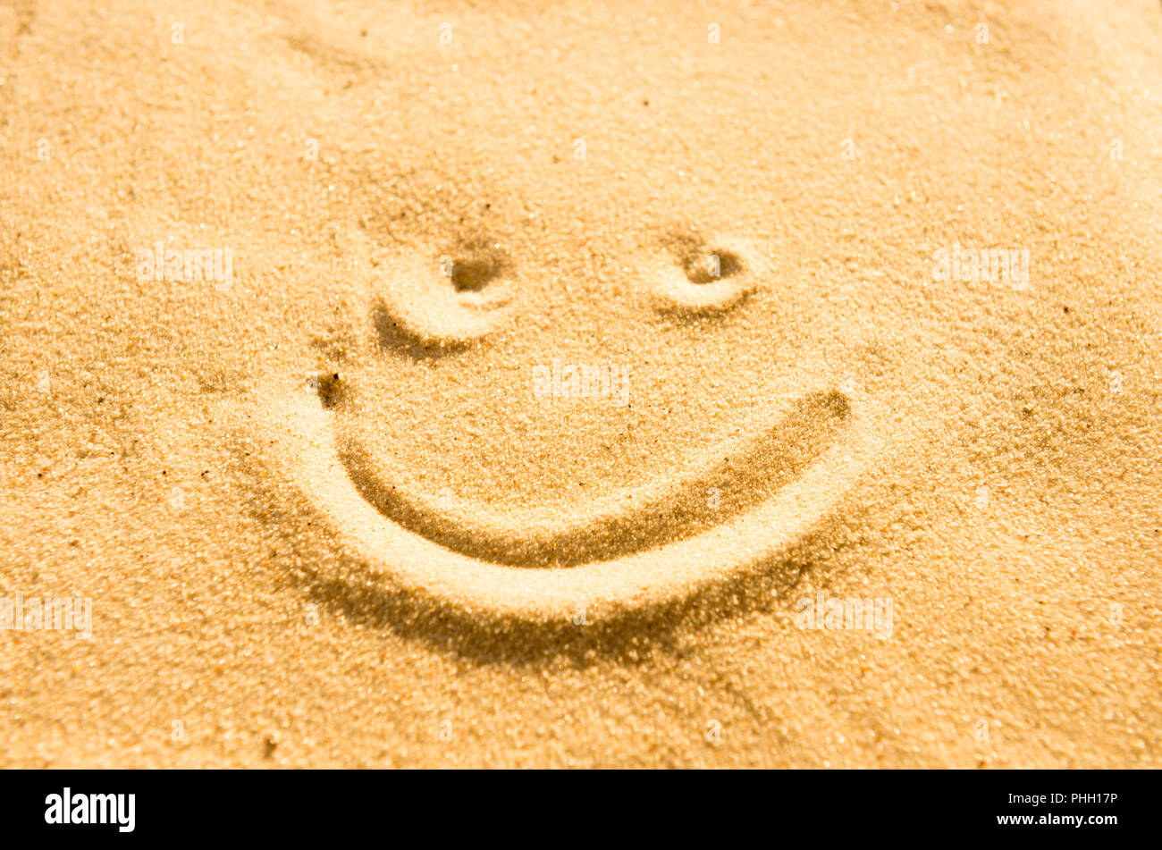 Smile on the sand Stock Photo - Alamy