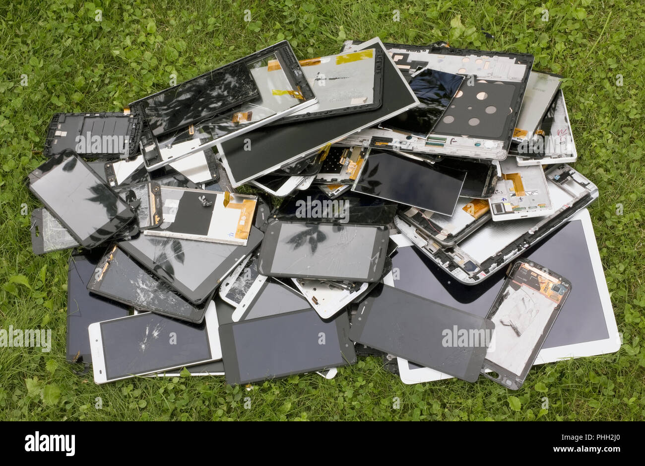 Broken tablets lie on summer lawn Stock Photo - Alamy