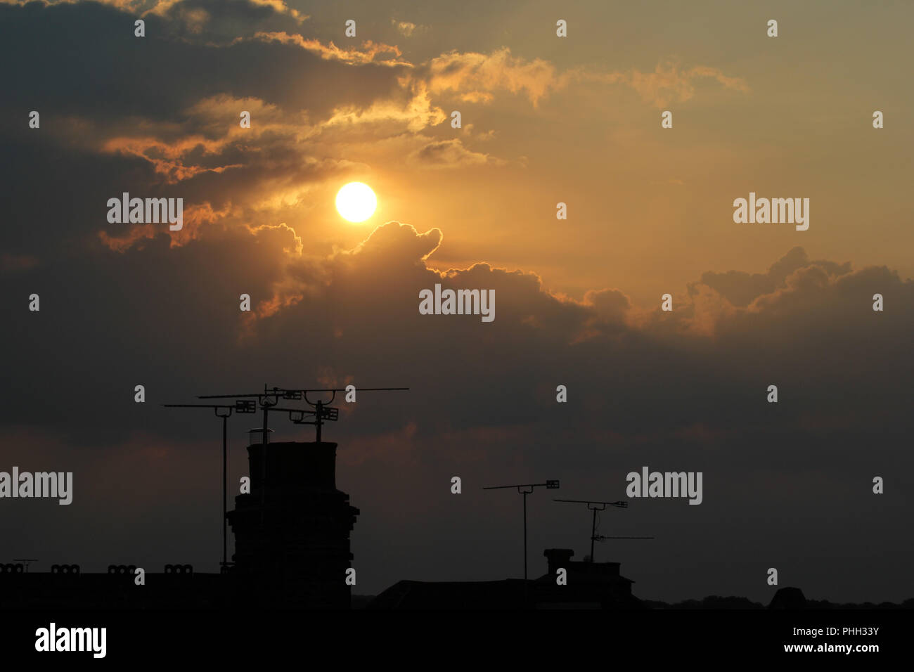 Sunset over rooftops Stock Photo - Alamy