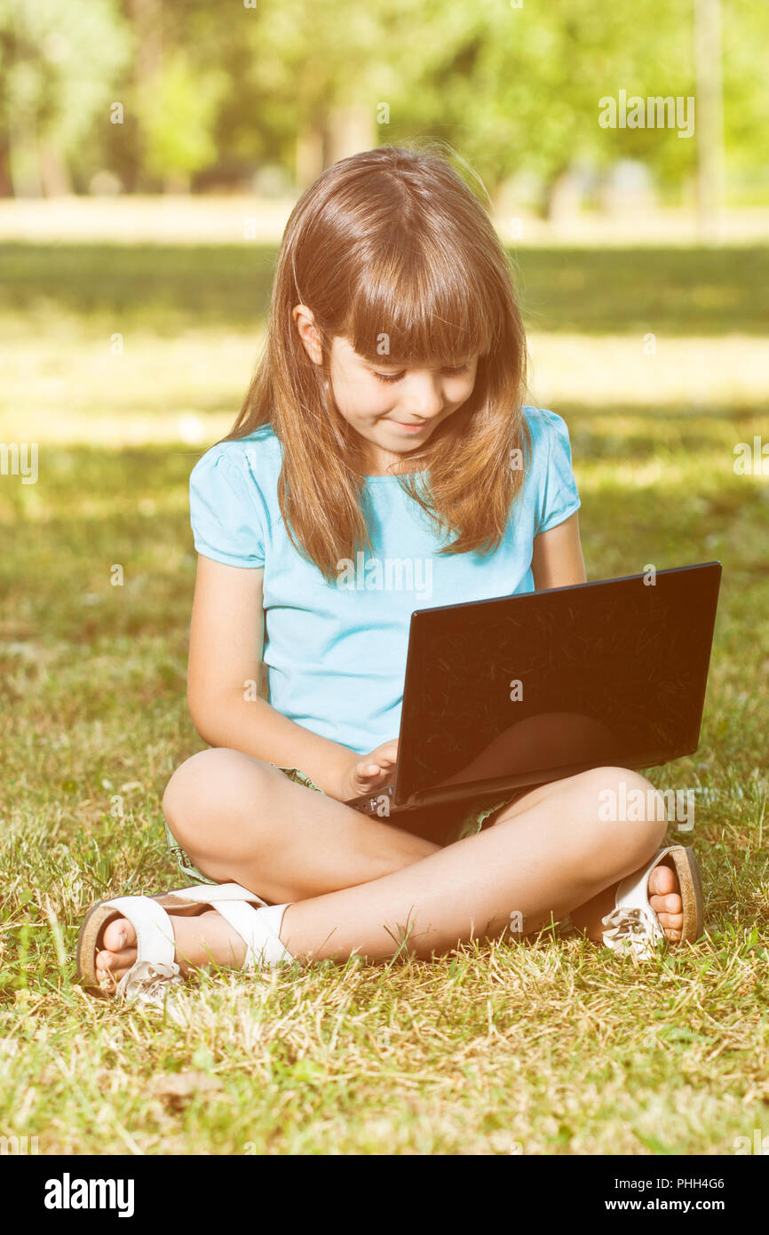 Little girl using laptop Stock Photo - Alamy