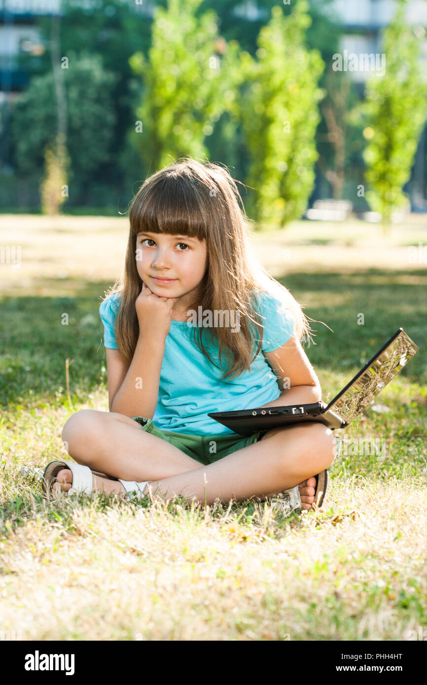 Little girl using laptop Stock Photo - Alamy