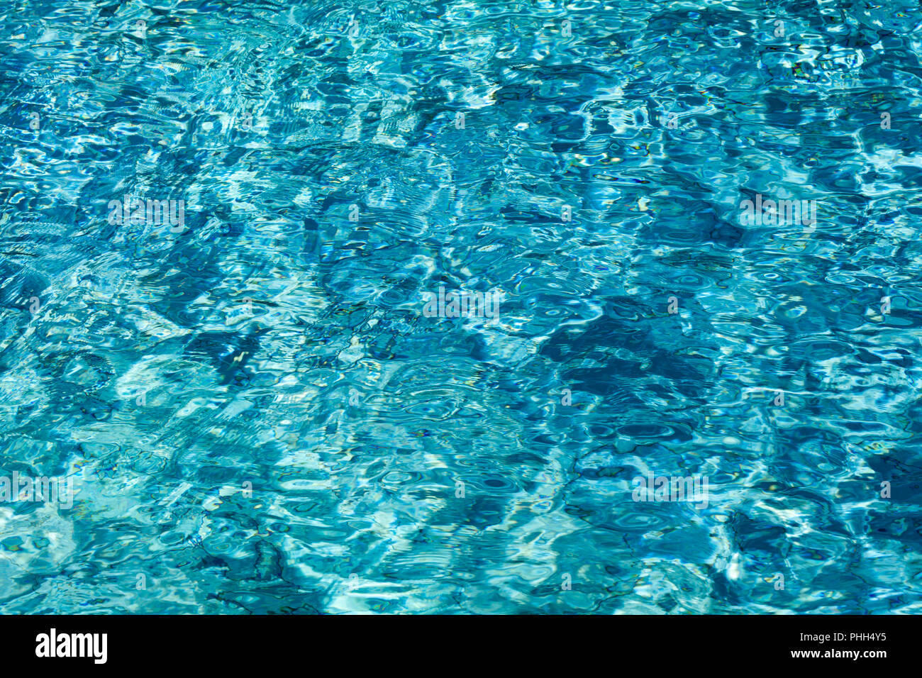 Blue water in the swimming pool with sun reflections Stock Photo - Alamy