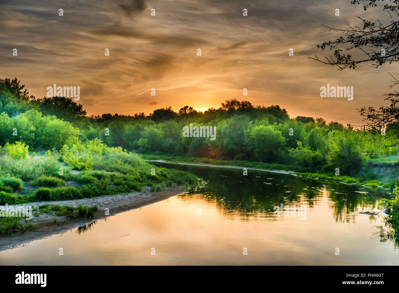 Sunset over river Stock Photo - Alamy