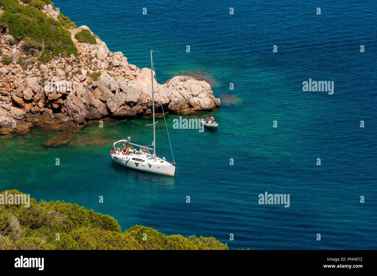 Landscape of sardinian coast with moored boats Stock Photo - Alamy