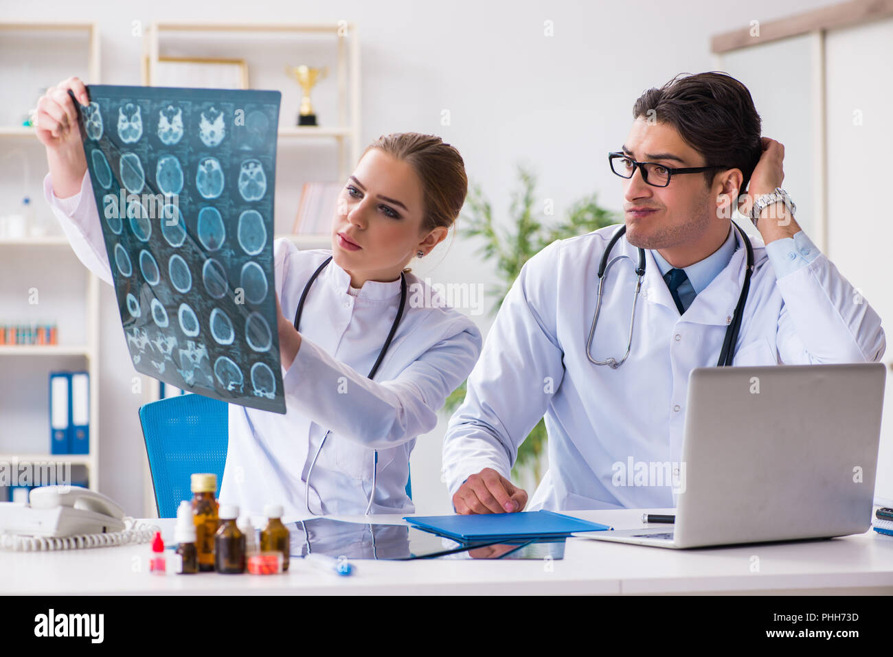 Two doctors examining x-ray images of patient for diagnosis Stock Photo ...