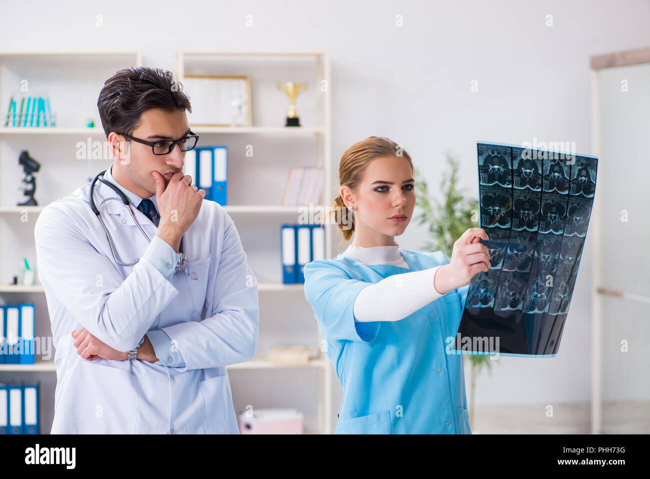 Two doctors examining x-ray images of patient for diagnosis Stock Photo ...