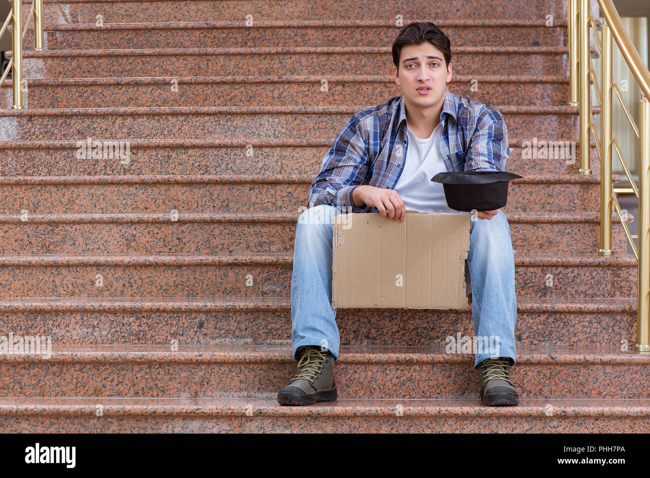 Young man begging money on the street Stock Photo - Alamy