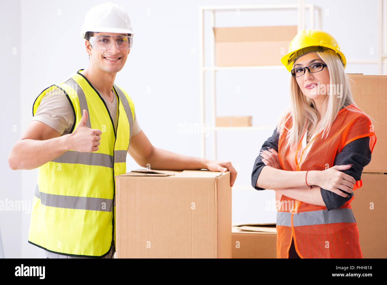 Delivery contractor delivering boxes to office Stock Photo - Alamy