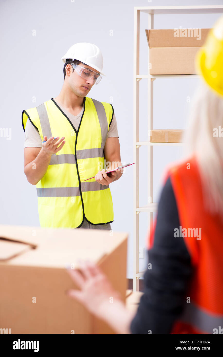 Delivery contractor delivering boxes to office Stock Photo - Alamy