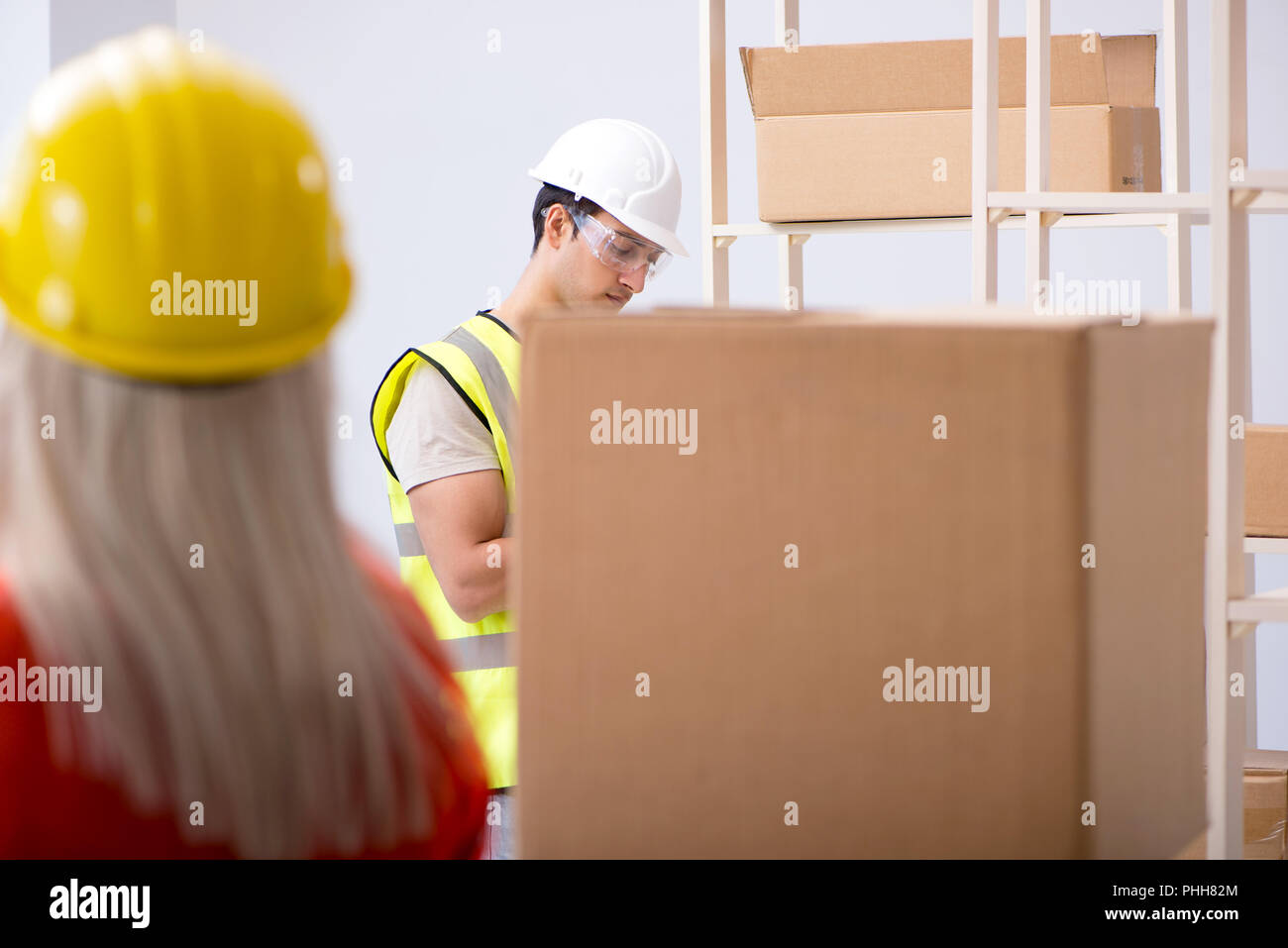 Delivery contractor delivering boxes to office Stock Photo - Alamy