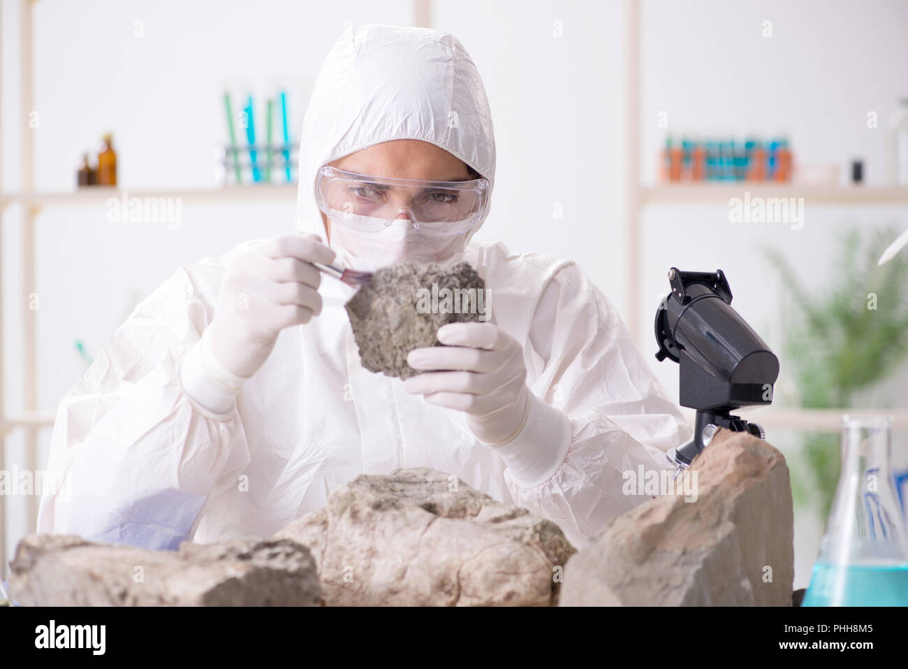 Scientist looking and stone samples in lab Stock Photo - Alamy